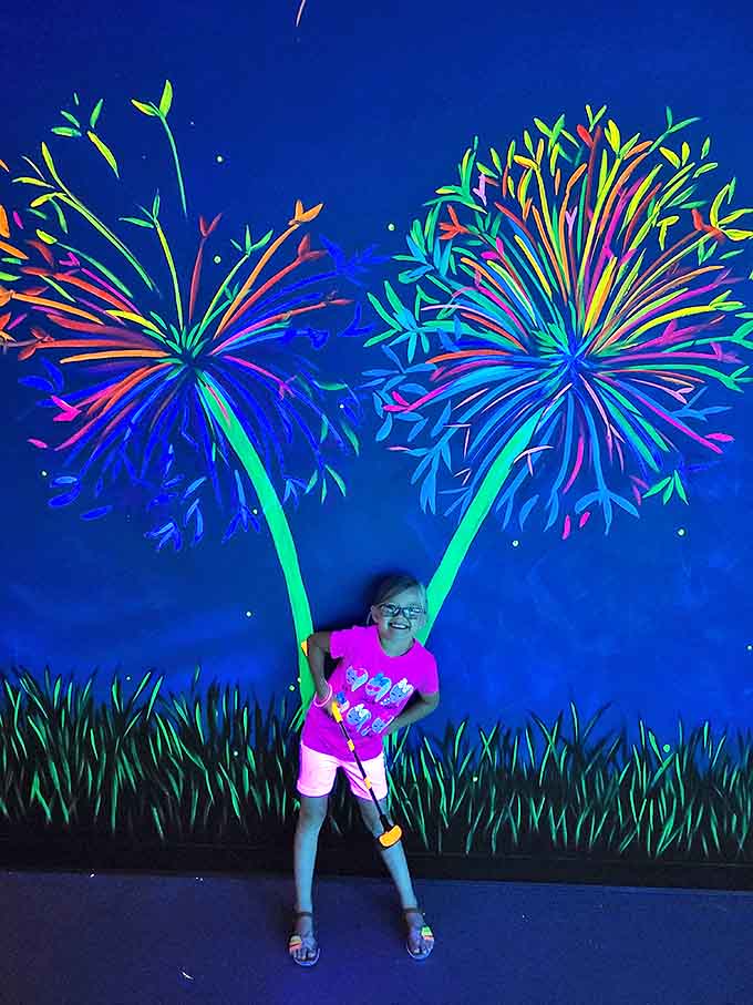 Pure joy radiates from this young golfer, proving that Glow In The Park creates memories that shine as brightly as its neon decorations.