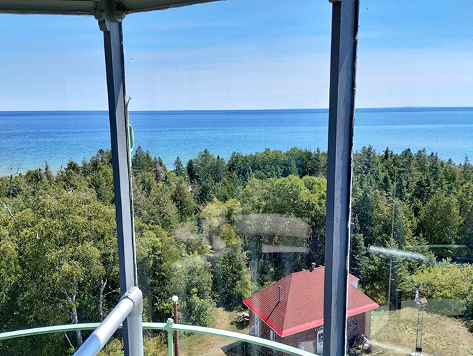 The view from inside the lantern room frames Lake Michigan's vastness, offering the same perspective that captivated keepers for over a century.
