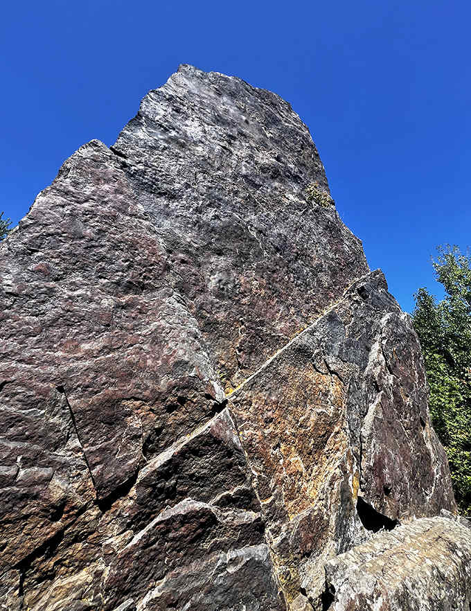 Framed against Minnesota's impossibly blue sky, this ancient stone sentinel commands attention. Its magnetic presence has drawn curious hikers for generations.