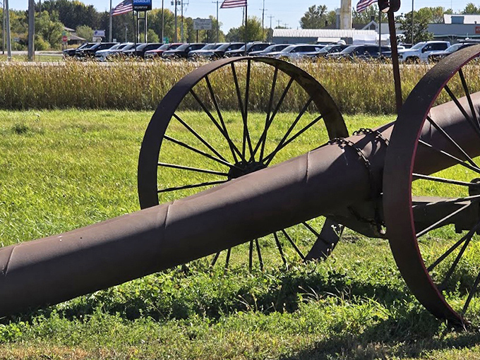 This antique farm implement rests peacefully in the grass, its working days behind it but its beauty eternally preserved.
