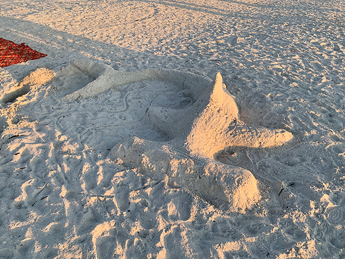 A sandy sculpture catches golden hour light, proof that Marco Beach inspires creativity in visitors of all ages.