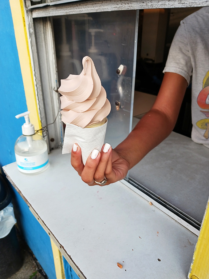 That magical moment of handoff, when the window becomes a portal to happiness one cone at a time.
