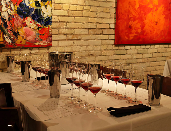 Wine glasses await a tasting flight &ndash; each ready to tell the story of its vineyard through color, aroma, and taste.