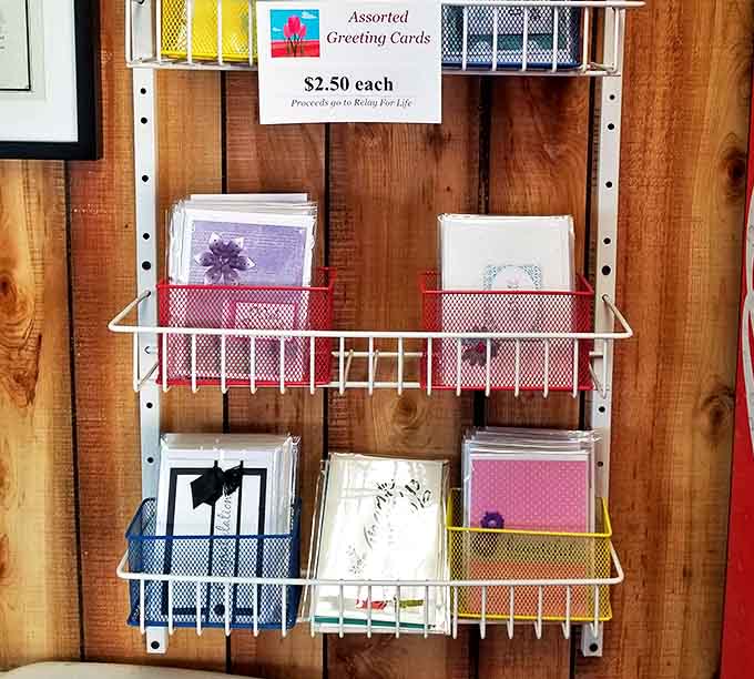 Even the greeting card rack speaks to community spirit – thoughtfully selected cards with proceeds supporting Relay For Life.
