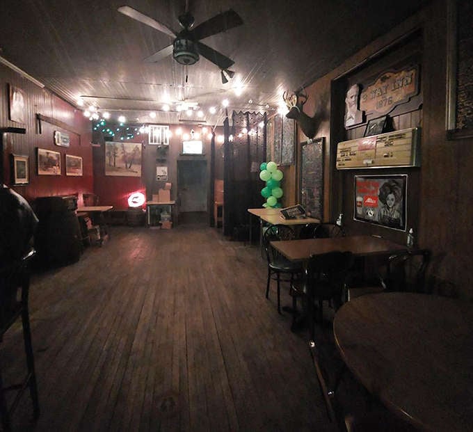 Back of the Bar: String lights cast a warm glow over wooden tables where strangers become friends and regulars feel like family.