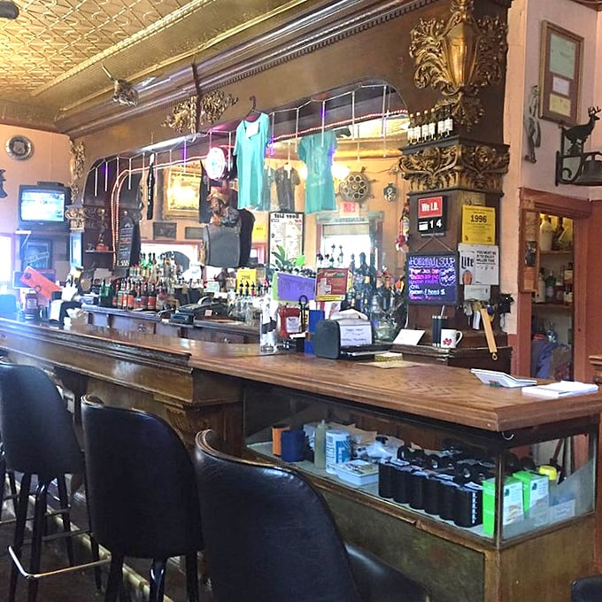 Behind this magnificent wooden bar, bottles gleam against ornate woodwork and a pressed tin ceiling &ndash; bartenders here don't need titles, just your name and usual order.