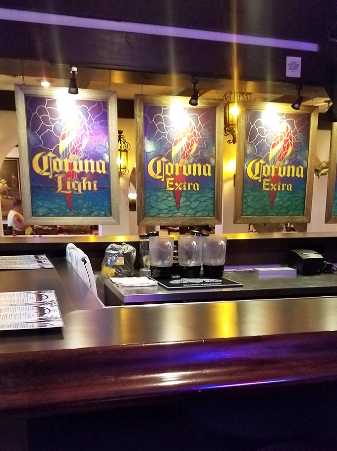 Stained glass Corona signs cast a colorful glow over the polished bar top, where generations of Detroiters have raised glasses in celebration.