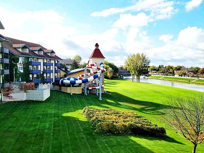 Expansive grounds feature recreational areas including water slides and green spaces, with the lodge's distinctive architecture as a stunning backdrop.