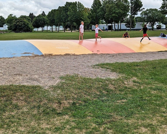 Bounce into joy: Kids discover the simple pleasure of defying gravity on the colorful bounce pad &ndash; childhood distilled to its essence.