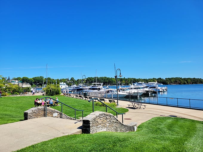 Boats bob gently at Charlevoix Marina, where water meets sky in a perfect tableau of lakeside leisure.