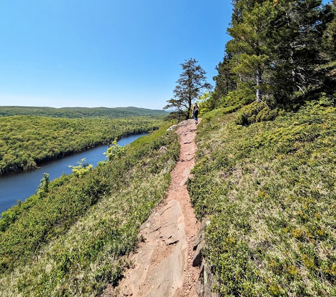 Hikers navigate this cliffside trail with Lake Superior shimmering below – nature's version of a high-wire act with spectacular views.