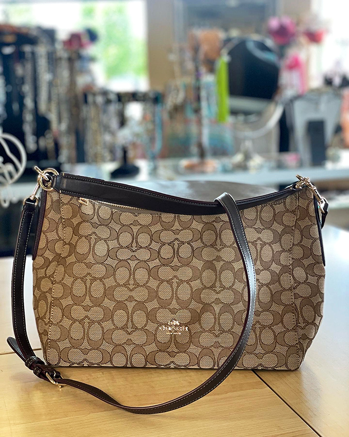 This classic Coach bag has aged like fine wine, its signature pattern a testament to timeless design and enduring quality.