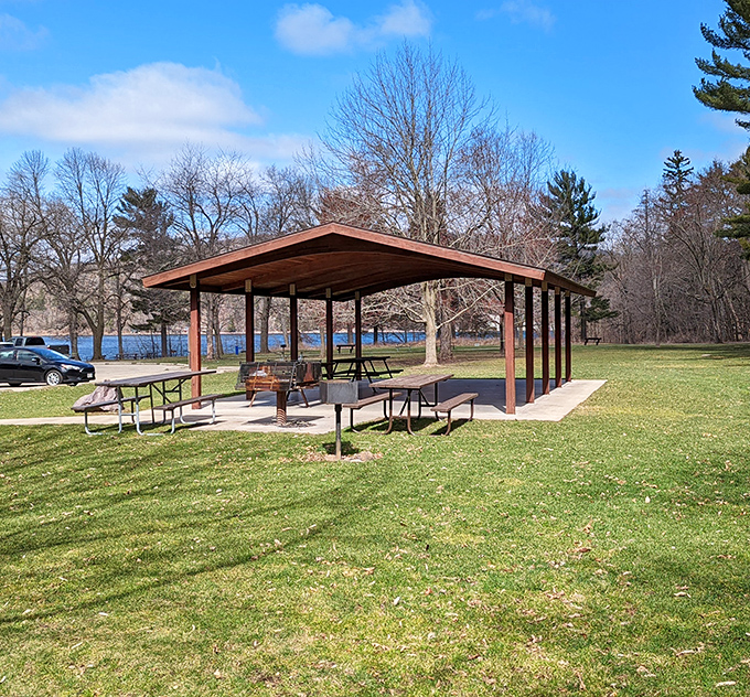 Picnic perfection awaits under rustic shelters, where generations have gathered to refuel after adventures on Devil's Lake's trails.