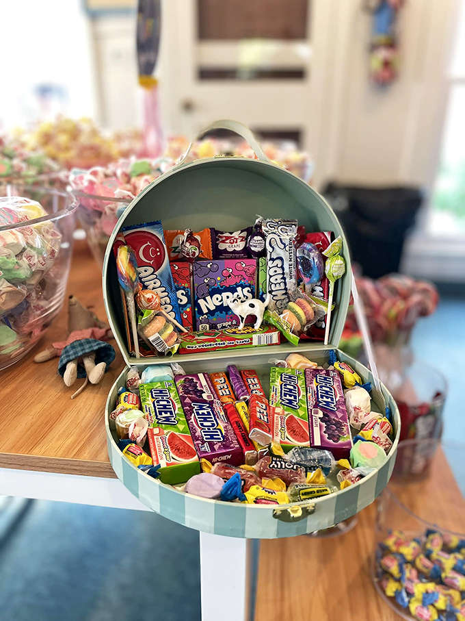 A mint-green hatbox treasure chest overflowing with nostalgic treats &ndash; the gift that says "I remember what it's like to be a kid."