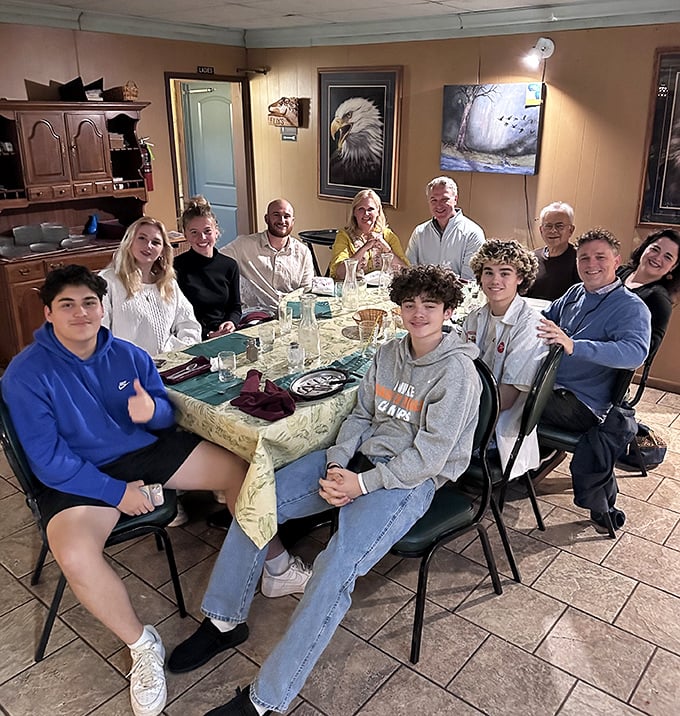 Families gather around tables creating memories – multiple generations sharing meals and moments in this timeless setting.