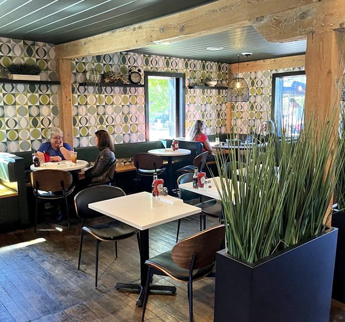 Potted grasses create natural dividers between tables, bringing the outdoors in while maintaining the restaurant's communal vibe.