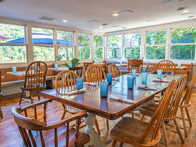 Sunlight floods the dining room through large windows, highlighting wooden tables that invite lingering conversations over second helpings.
