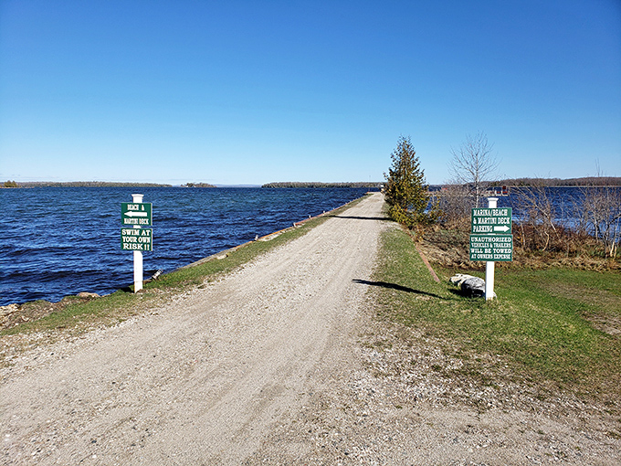 Causeway Road: The island's main artery stretches between two shades of blue, with helpful signs pointing to adventures in either direction.