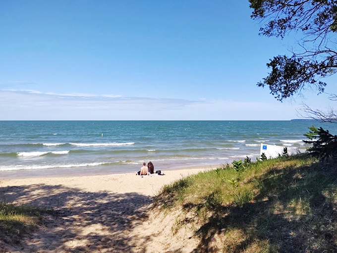 Sandy pathways lead to blue horizons, creating the perfect entrance for your day of lakeside relaxation.