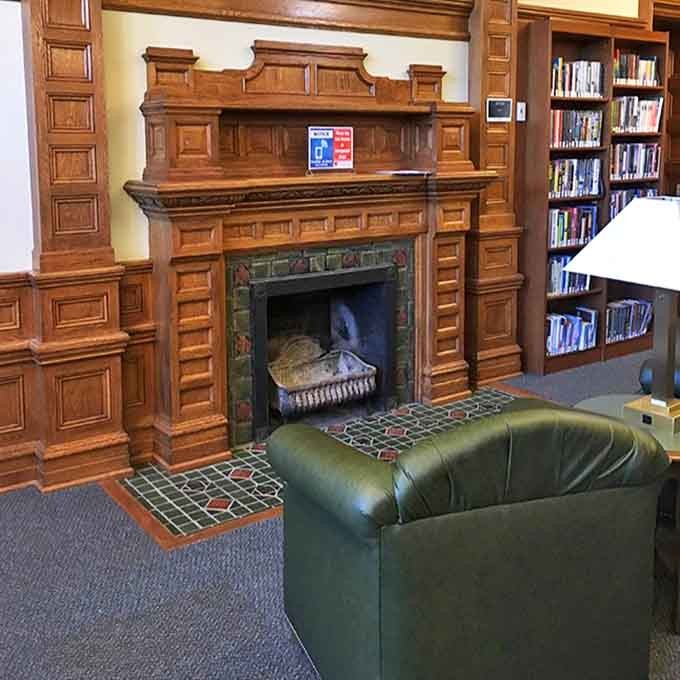 This isn't just a fireplace &ndash; it's the heart of the library's historic reading room, where ornate woodwork frames a cozy spot for literary contemplation.