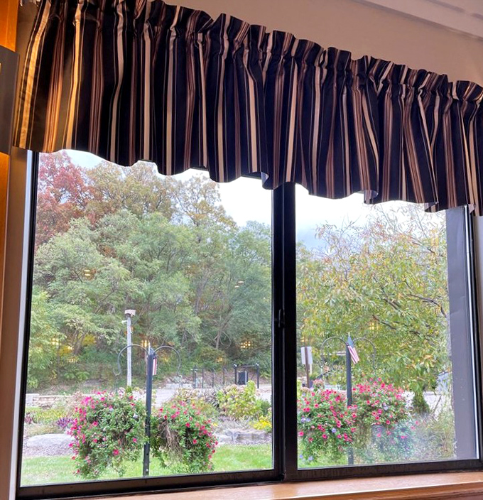 Through the windows, hanging flower baskets add splashes of color, creating a peaceful backdrop for morning indulgences.