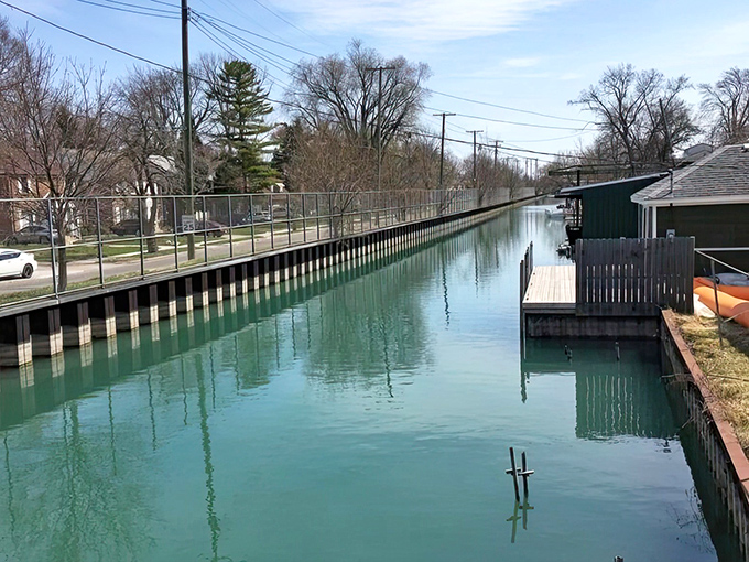 Summer algae creates a striking green palette in this historic canal section, where urban waterways have shaped community life for generations.