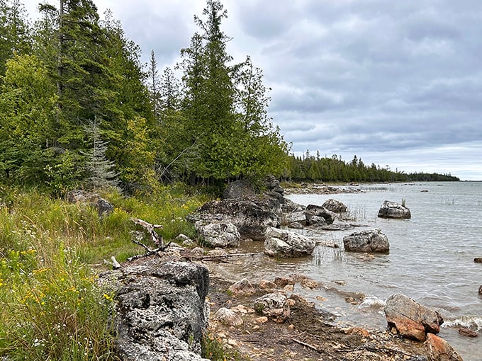 Lake Huron stretches to the horizon, its waters shifting from turquoise to sapphire as clouds play hide-and-seek with the sun.