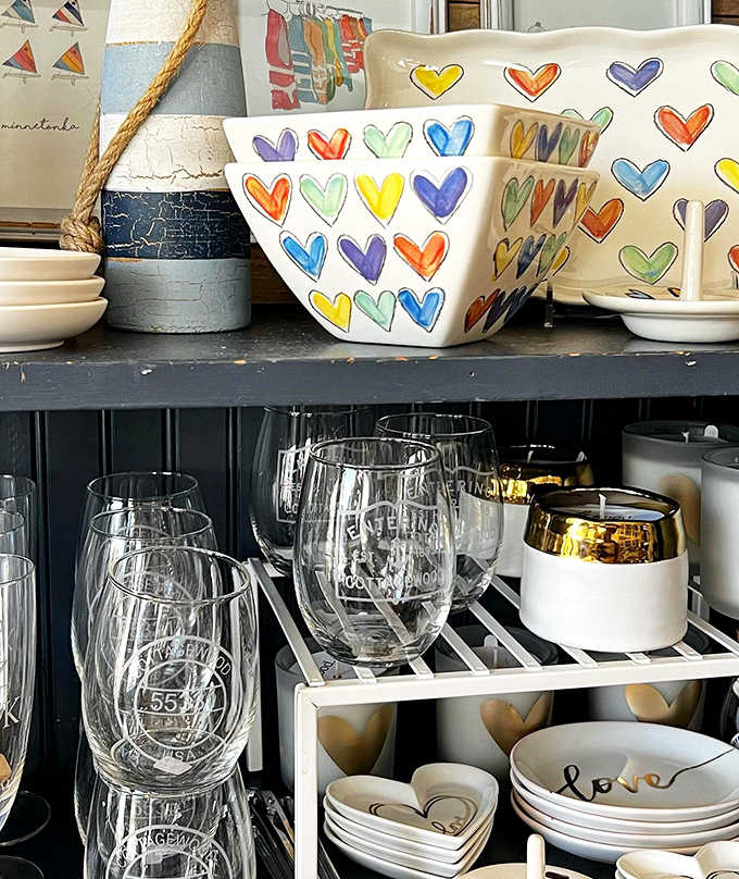Colorful heart-patterned bowls and glassware add whimsical charm to the carefully curated gift selection.