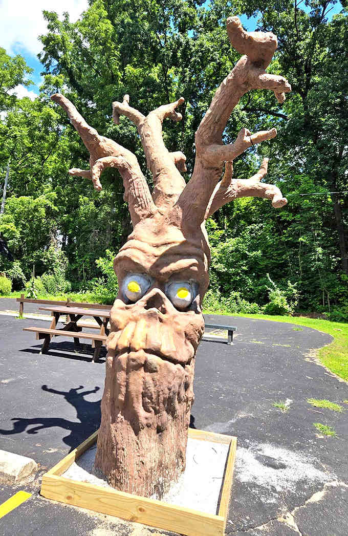 This carved tree creature looks like it wandered out of a fairy tale and decided to stay, adding whimsy to the already eccentric landscape.