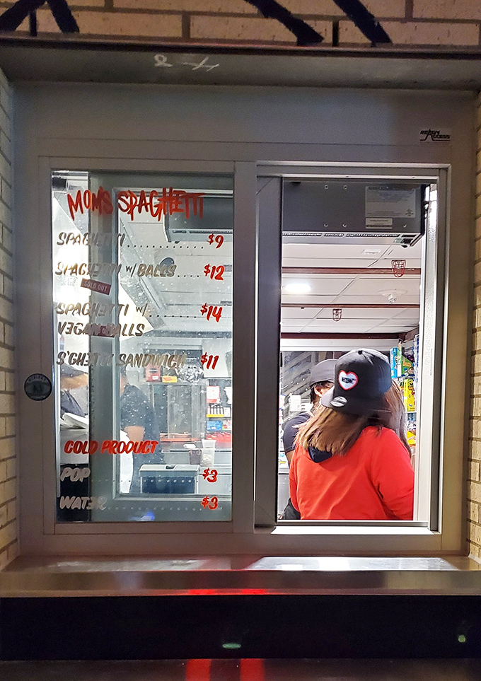 The outdoor service window offers a glimpse into pasta paradise, where hungry patrons can grab their spaghetti fix on the go.