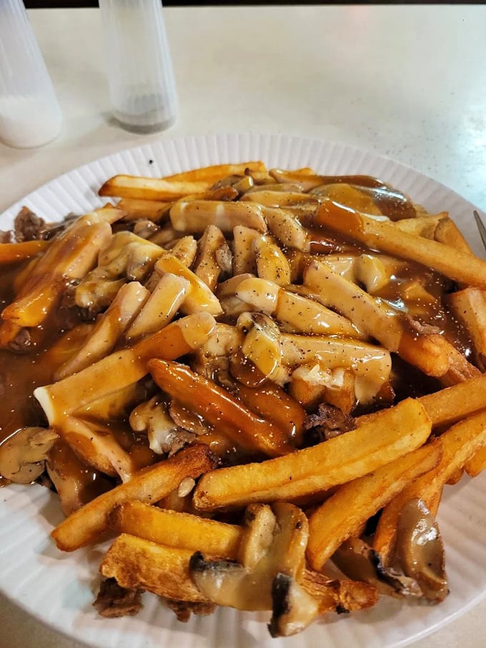 Michigan's answer to poutine – crispy fries smothered in savory gravy and mushrooms – proves that sometimes the messiest foods are the most satisfying.