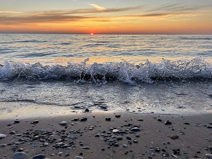 Smooth stones line the shore like nature's own mosaic, each one tumbled by Lake Michigan into a perfect skipping stone or pocket treasure.