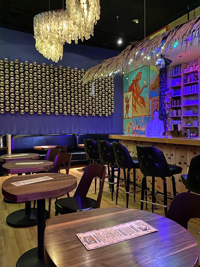 The tiki bar's vibrant murals and bamboo details create an atmosphere that's part tropical getaway, part art installation.