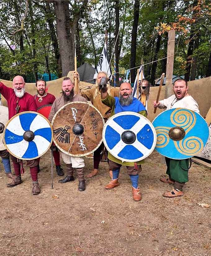 Viking warriors display their fearsome shields and weapons with battle cries that echo through the trees, their beards alone worthy of respect.