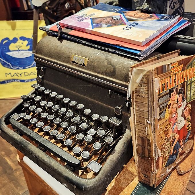 A vintage typewriter sits ready for inspiration, surrounded by the very books it might have once helped create.