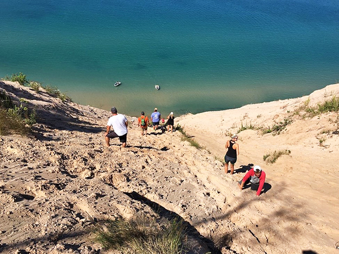 Brave souls navigate the famous dune climb, where each sliding step down means twenty laborious ones back up.