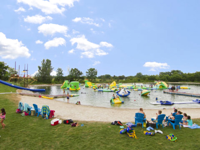 Family paradise from shore to water &ndash; beach chairs, towels, and inflatable adventures create the perfect summer tableau.