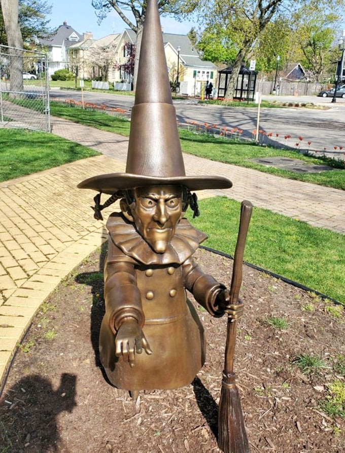 The Wicked Witch of the West looms with her broomstick at the ready, her pointed hat and menacing stance instantly recognizable.