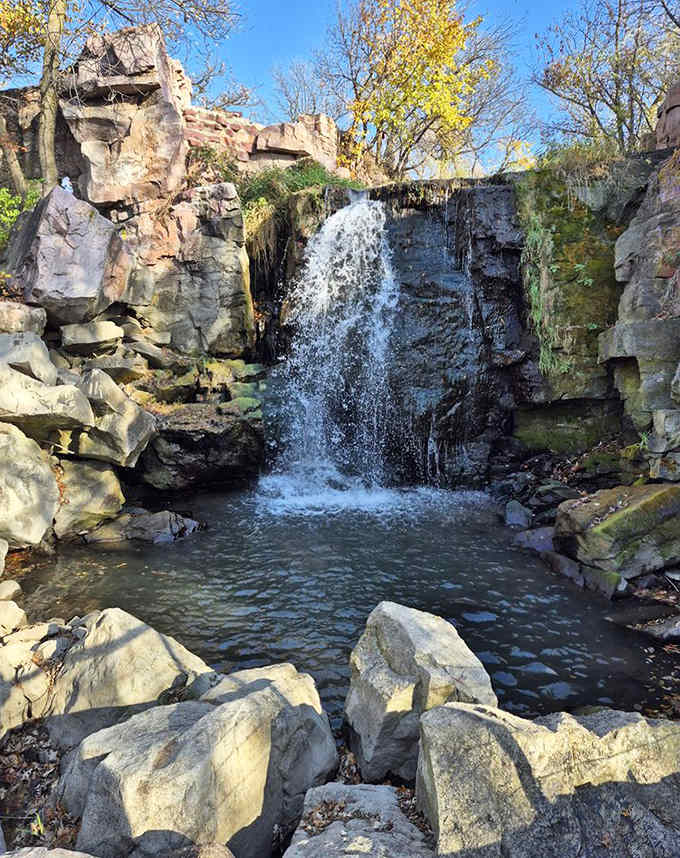 Winnewissa Falls cascades gracefully over pink quartzite ledges, creating a peaceful oasis that has drawn visitors for generations.