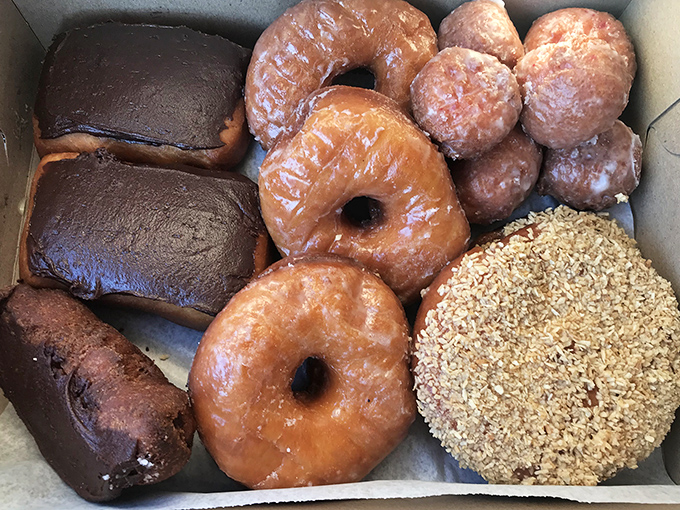 This isn't just a box of donuts – it's portable happiness, a cardboard container of joy that transforms any ordinary day into a celebration.