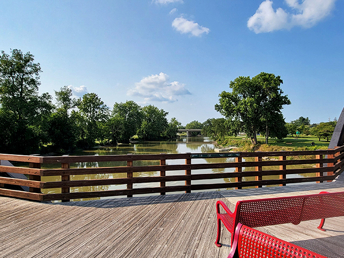 Tranquil waters reflect puffy clouds sailing overhead, creating a moment of perfect symmetry between earth and sky.