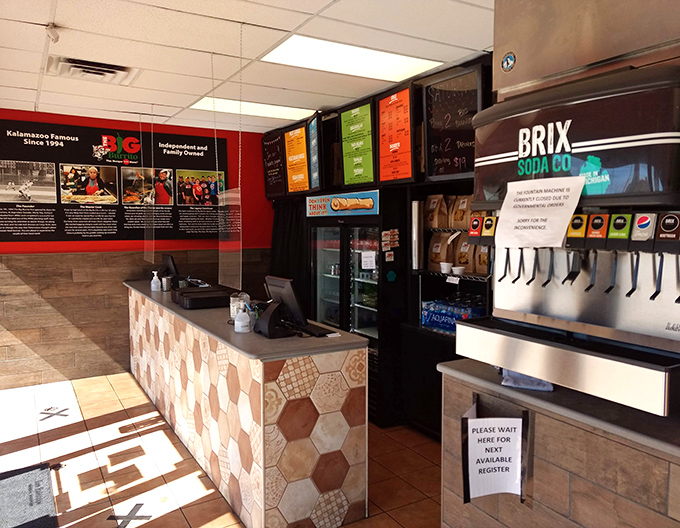 The cashier station serves as command central, where friendly staff orchestrate the delicious chaos with practiced efficiency and genuine smiles.