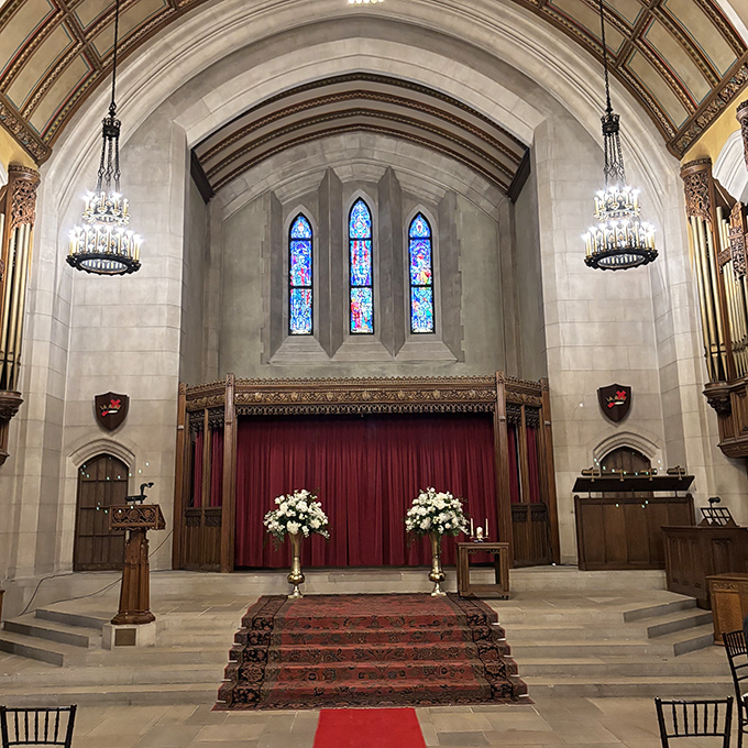 Stained glass windows cast colorful light across this sacred space, creating an atmosphere of reverence perfect for ceremonies and contemplation.
