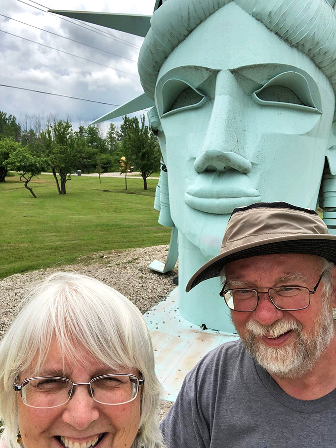 Visitors find themselves dwarfed by Lady Liberty's mint-green visage, proving that freedom looks just as impressive in Michigan as it does in New York Harbor.