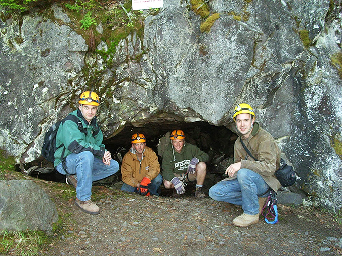 Hard hats and big smiles &ndash; these modern-day explorers gather at the threshold of an underground adventure.