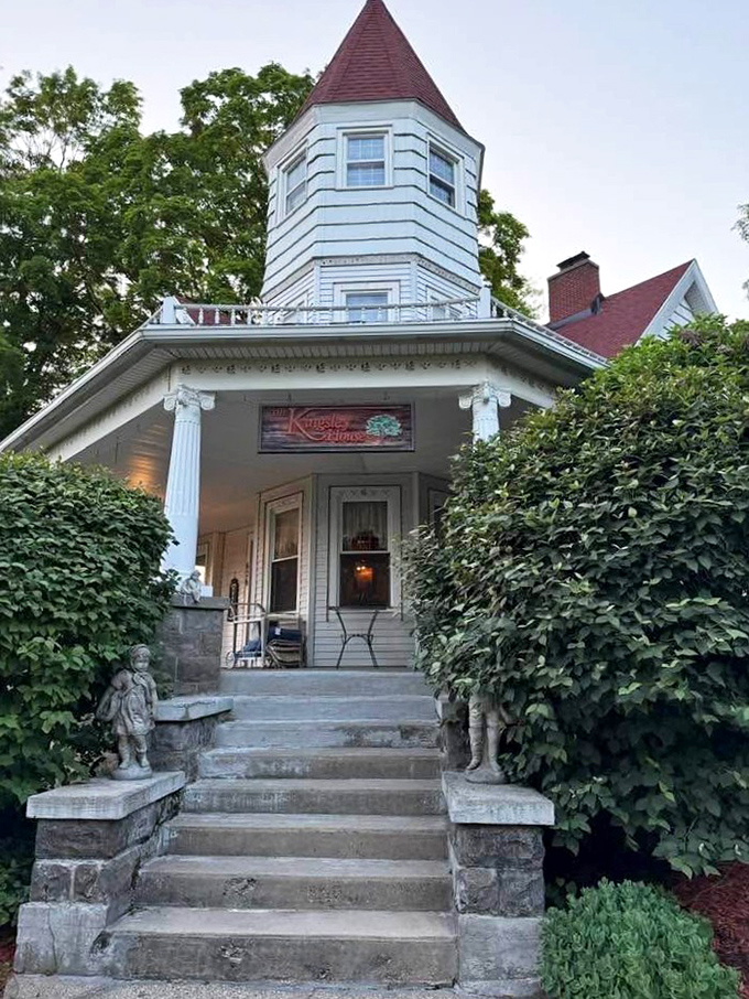 Stone steps lead to a columned entrance where Victorian architecture announces itself with quiet confidence.