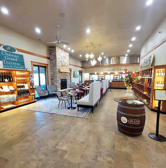 The interior lounge area offers comfortable seating around a stone fireplace – perfect for savoring that special reserve bottle.