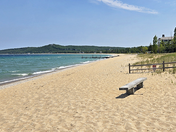 A lone bench awaits contemplative souls, offering front-row seats to nature's greatest show on Lake Street Beach.