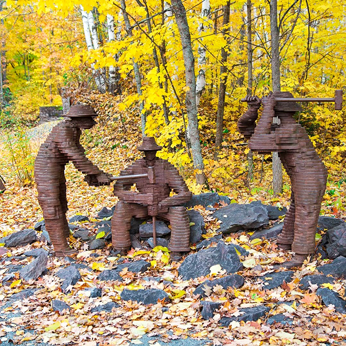 This artistic iron sculpture captures miners' daily reality, where metal art honors metal workers in a perfect full-circle tribute.