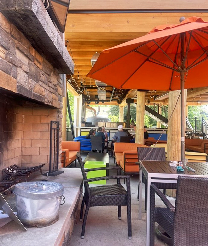 Orange umbrellas and comfortable seating create a heavenly outdoor sanctuary for enjoying Michigan's perfect summer afternoons.